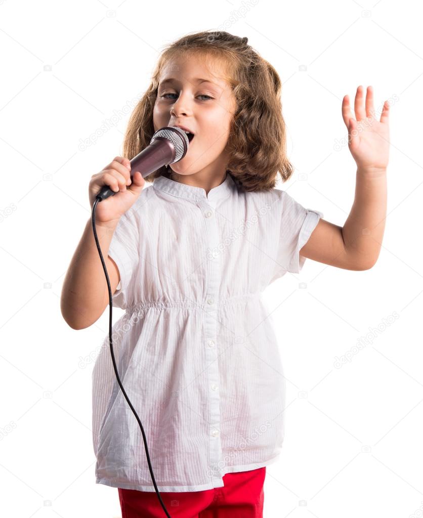 Girl singing with microphone Stock Photo by ©luismolinero 85056034