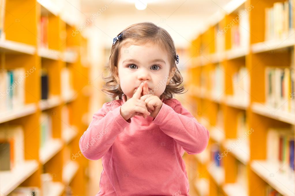 Cute girl doing silence gesture over white background Stock Photo by ...