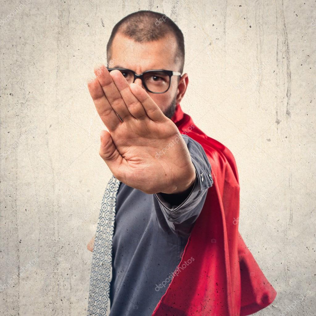 Super hero making stop sign Stock Photo by ©luismolinero 94375460