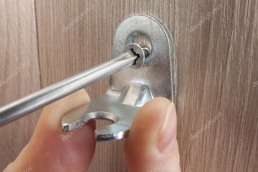 Screw Being Screwed In Wooden Furniture Using Phillips Screwdriver
