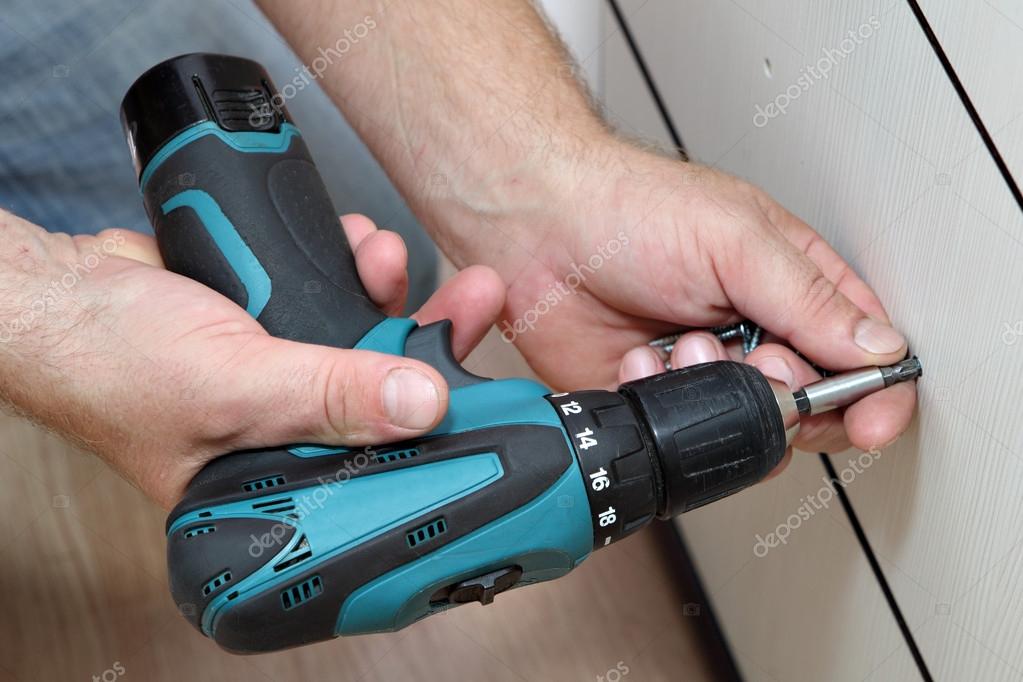 Using cordless screwdriver for screwing screws when assembling ...