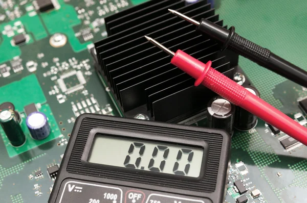 Close-up multimeter on PCB plate. Stock Photo by ©stalnyk 40668943