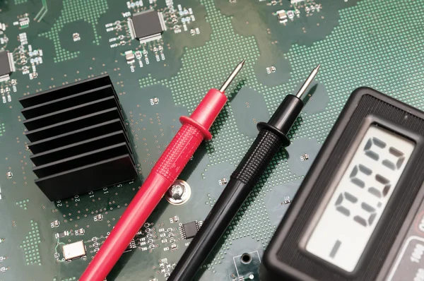 Close-up multimeter on PCB plate. Stock Photo by ©stalnyk 40668943