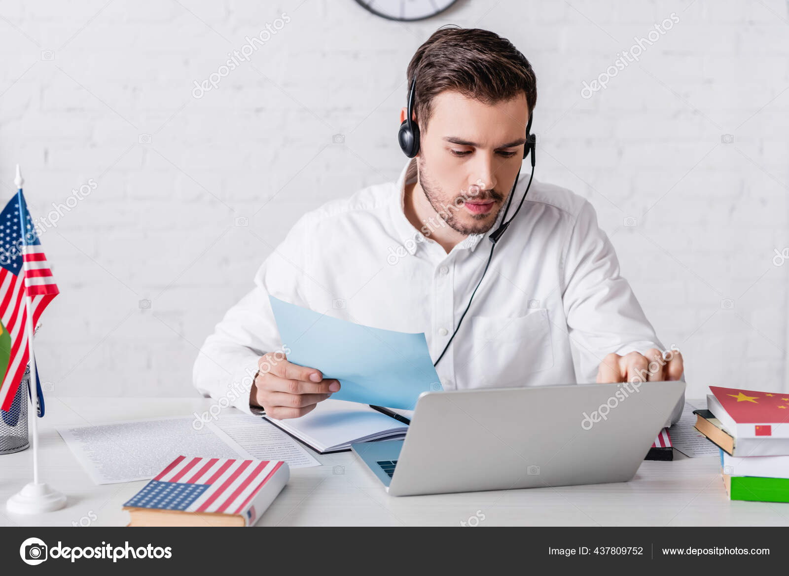 Young Translator Headset Holding Document While Working Laptop ...