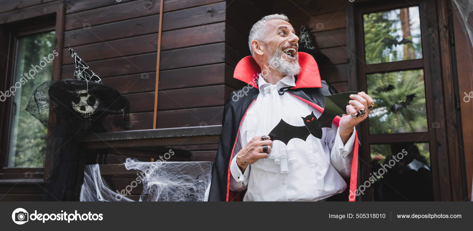 Laughing Middle Aged Man Halloween Vampire Costume Holding Paper Cut ...