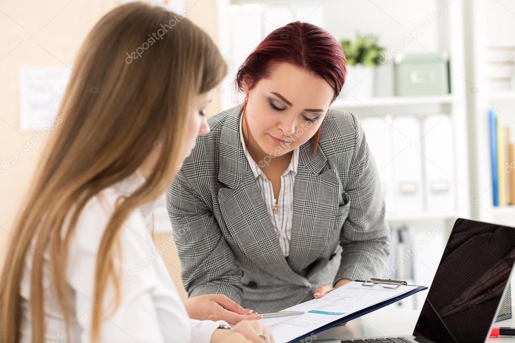Two female auditors looking at financial report — Stock Photo © Dutko ...