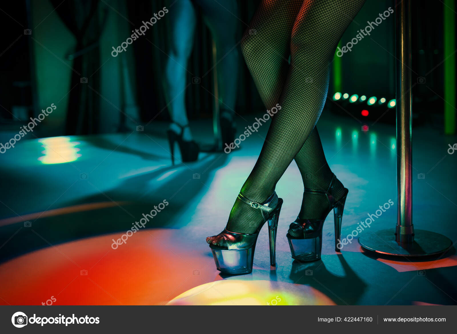 Heels Of Sexy Woman Pole Dancing Or Striptease Pylon In Night Club