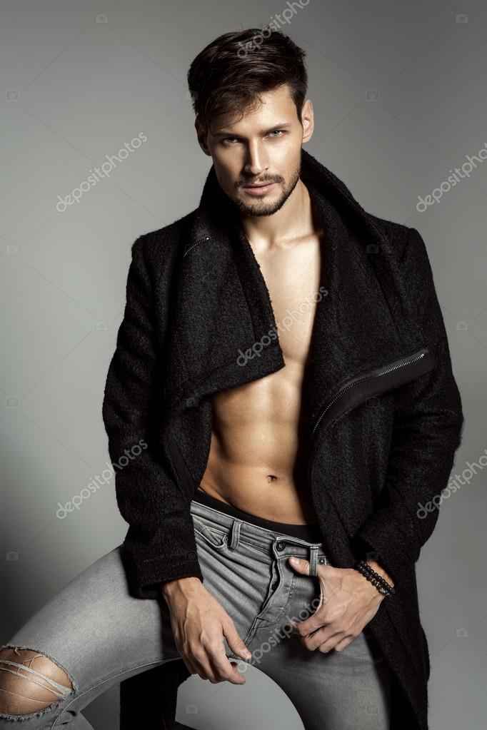 Young handsome model posing Stock Photo by ©kiuikson 97271380