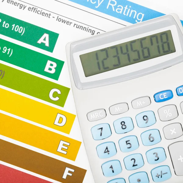 Calculator over energy efficiency chart - studio shot - 1 to 1 ratio ...