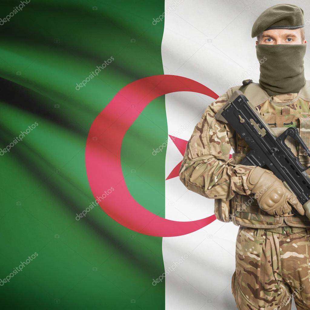 Soldier with machine gun and flag on background - Algeria Stock Photo ...