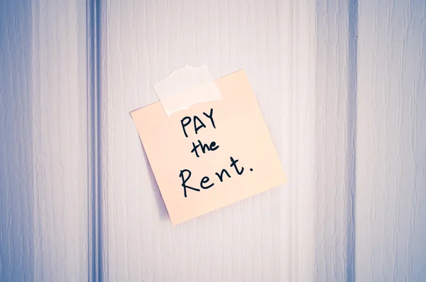 Sticky note write a message pay the rent Stock Photo by ©ammza12 56761051