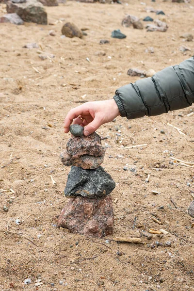 Person stacking stones Stock Photos, Royalty Free Person stacking ...