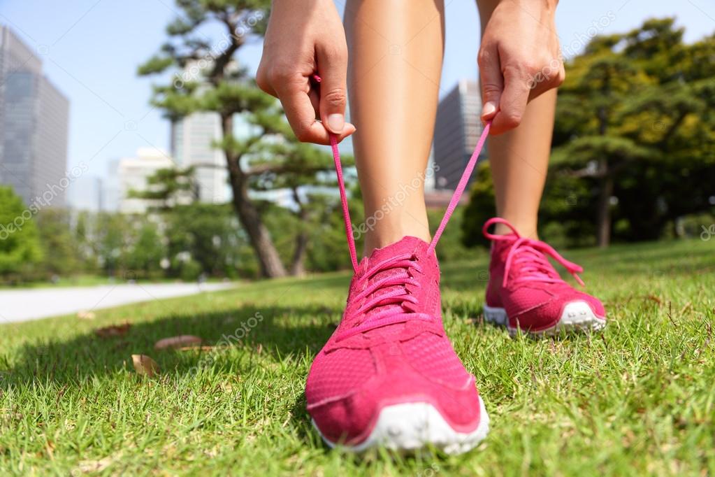 Runner tying running shoes laces — Stock Photo © Maridav #72653293