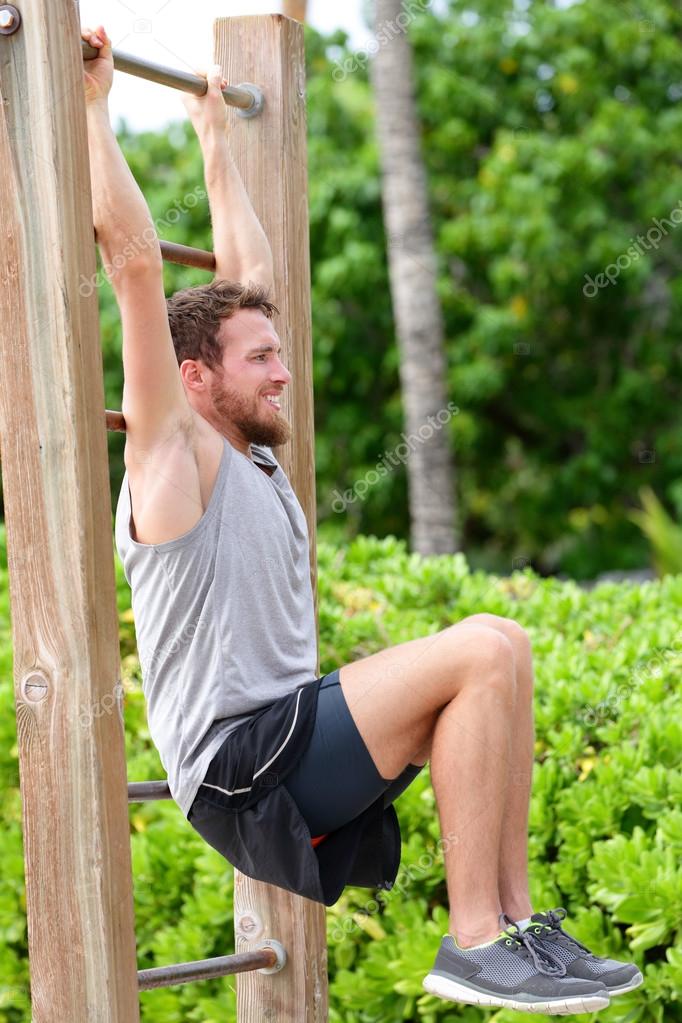 Man training core muscles with leg lift Stock Photo by ©Maridav 72653489