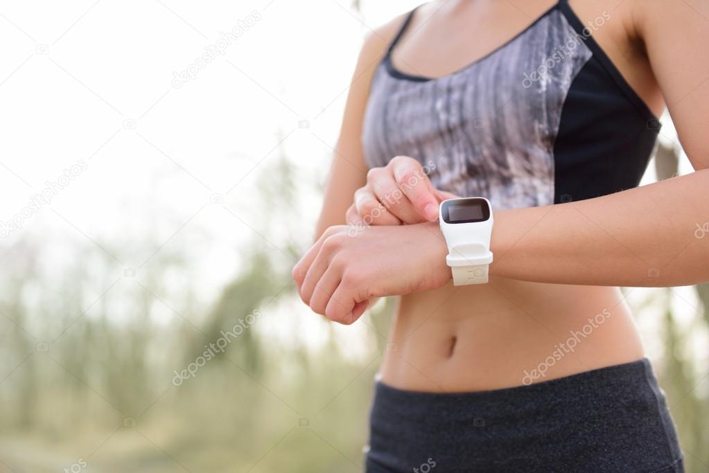 Runner looking at sports smartwatch — Stock Photo © Maridav #73838139