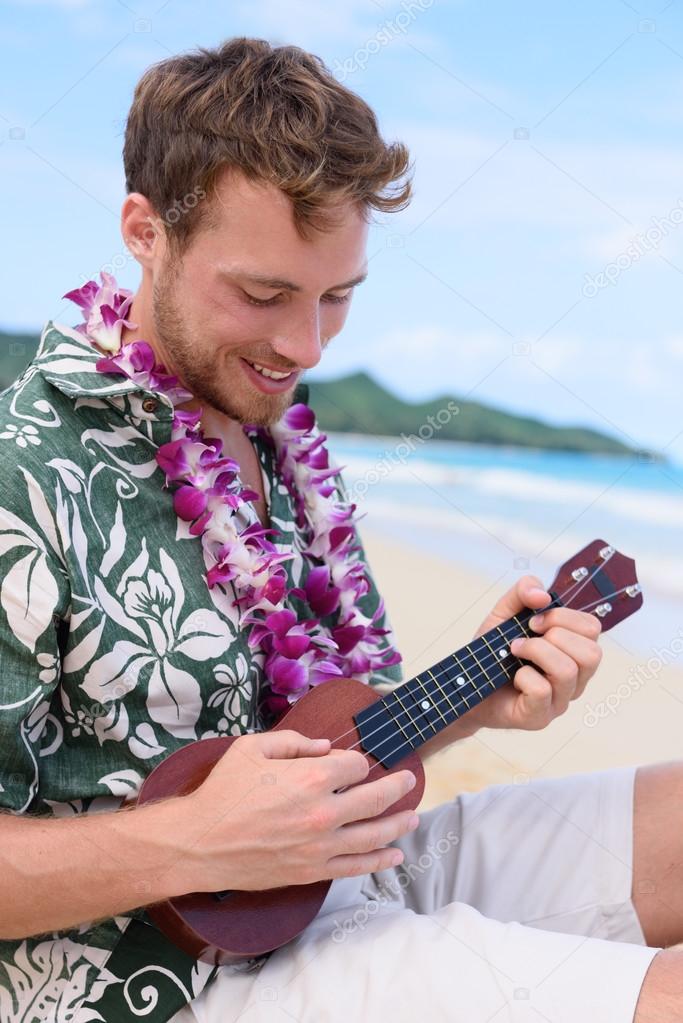 Man on beach playing ukulele instrument — Stock Photo © Maridav #97343960
