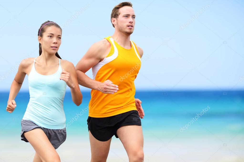 Runners running on beach Stock Photo by ©Maridav 97352238