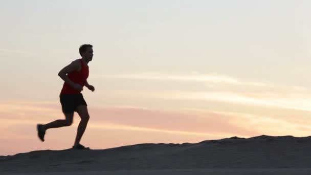 Athlete running at sunset on beach Stock Photo by ©Dirima 27317245