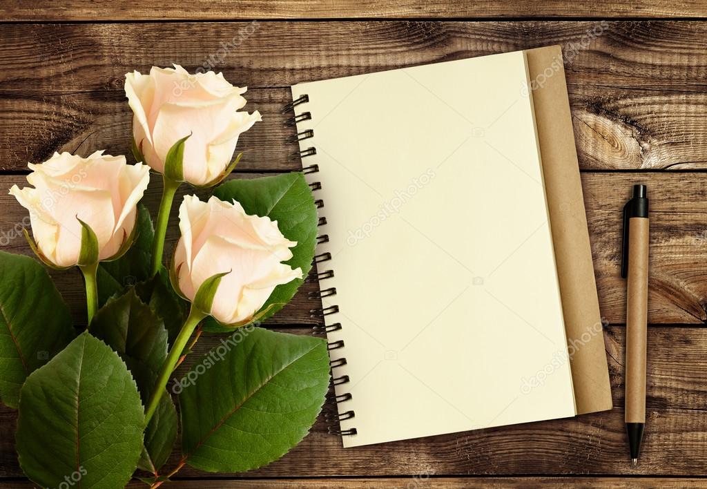 White rose flowers with notebook and pen Stock Photo by ©ksushsh 106751352