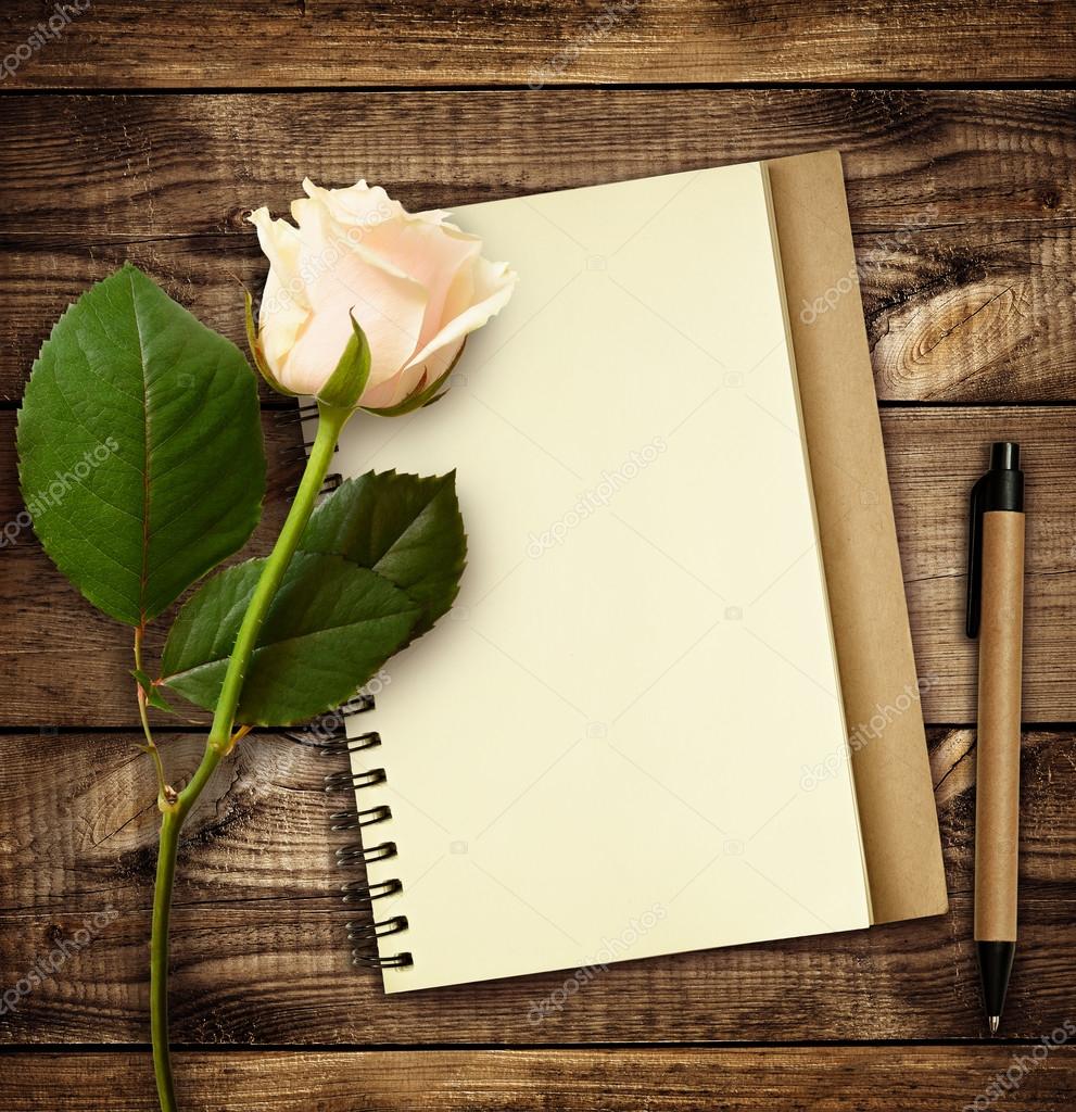 White rose flower with notebook and pen Stock Photo by ©ksushsh 106752498