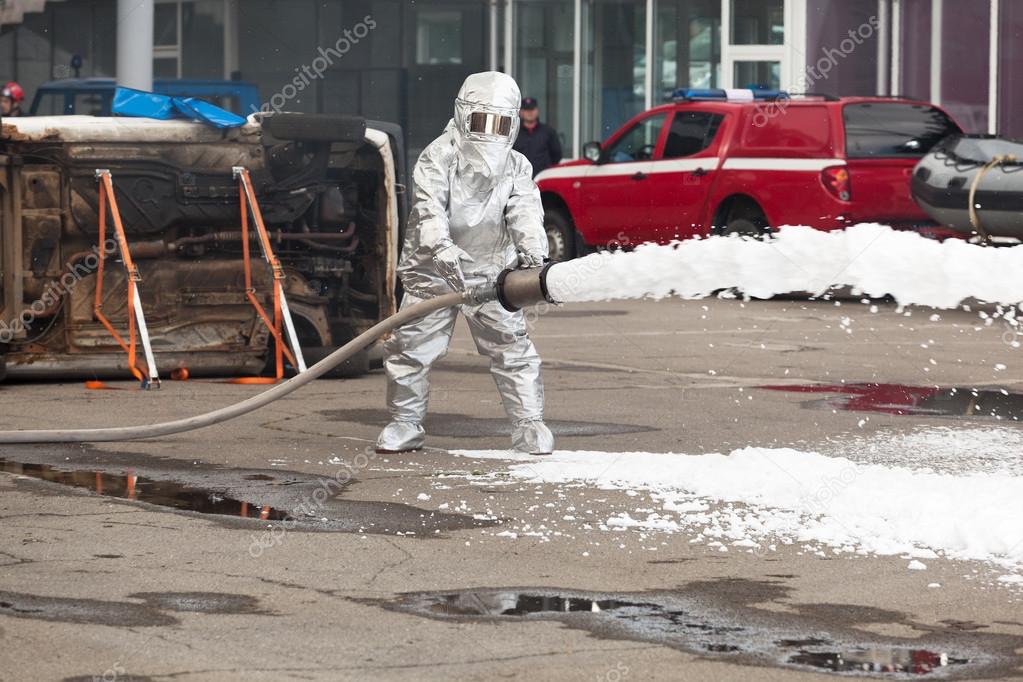 Firemen spray firefighting foam — Stock Photo © macor #71803787
