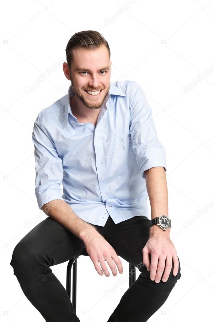 Smiling man sitting down — Stock Photo © -Robbie- #69569529 Smiling man sitting down — Stock Photo © -Robbie- #69569529