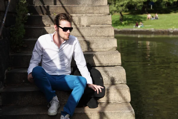 Man sitting down outside worried Stock Photo by ©-Robbie- 36952409