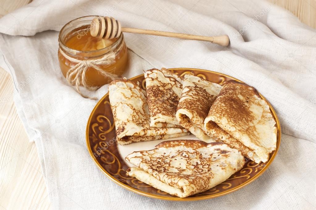 Golden crepes with honey Stock Photo by ©amberto4ka 73637547
