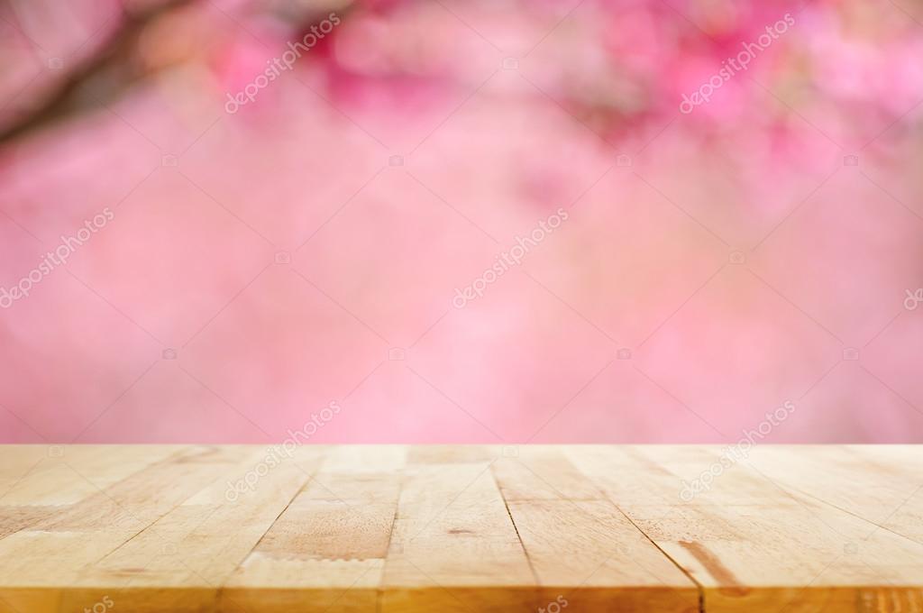 Wood table top on blurred background of pink cherry blossom flower ...