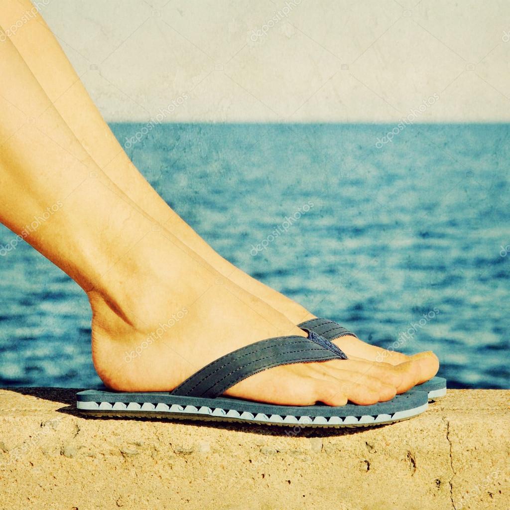 Female feet in blue flip-flops, retro image Stock Photo by ...