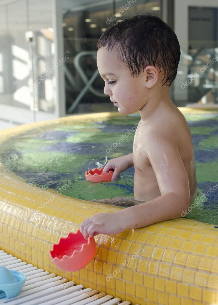 Child playing in swimming pool Stock Photo by ©pavsie 61919421