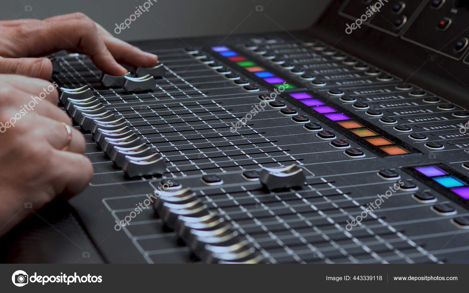 Man works on a professional electronic audio mixer. A control panel for ...