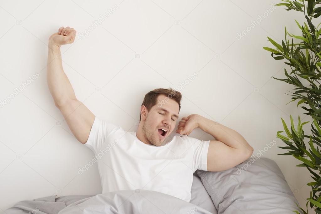 Man woke up and raised fists Stock Photo by ©gpointstudio 114864944