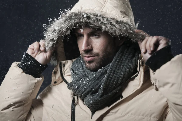 Handsome man in snow storm - Stock Image - Everypixel