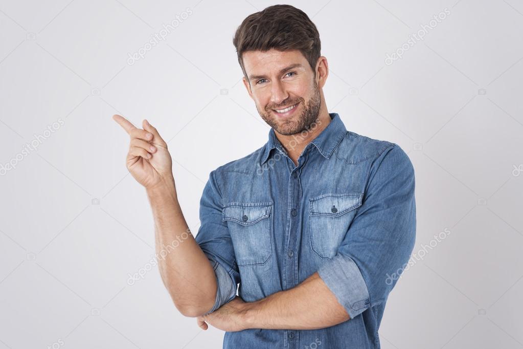 Handsome man pointing — Stock Photo © gpointstudio #58774357