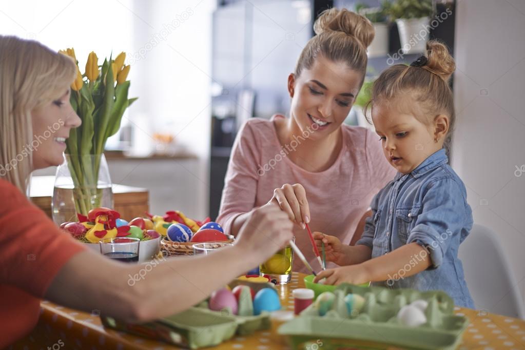 Family decorating Easter eggs Stock Photo by ©gpointstudio 65146767
