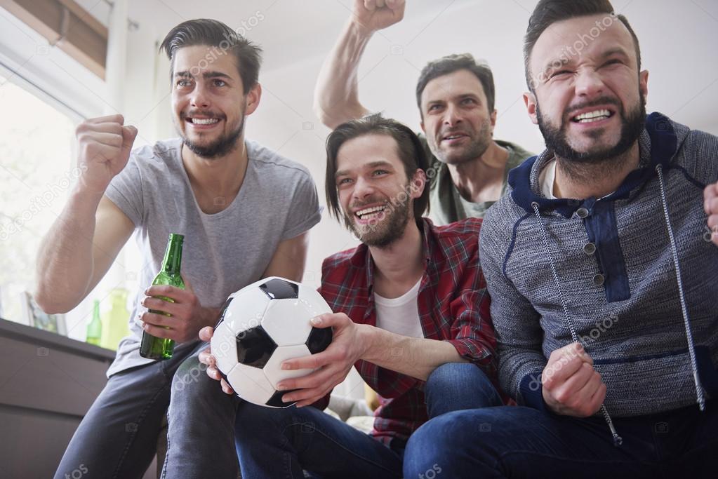 Group of men watching football match Stock Photo by ©gpointstudio 72826371