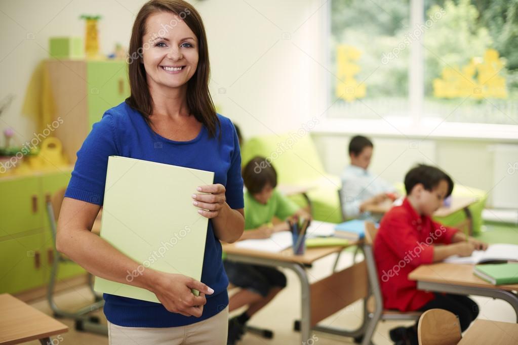 Beautiful female teacher while lesson — Stock Photo © gpointstudio ...