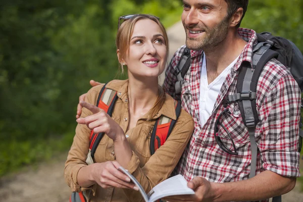 Couple looking helpful information in guide - Stock Image - Everypixel