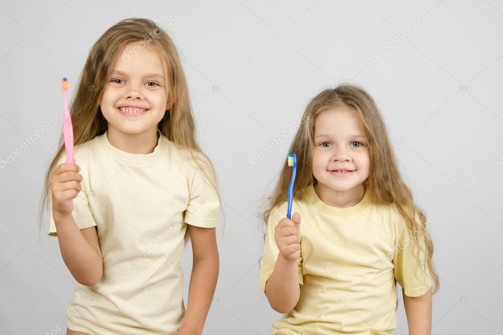 Two girls with toothbrushes Stock Photo by ©Madhourses 75770205