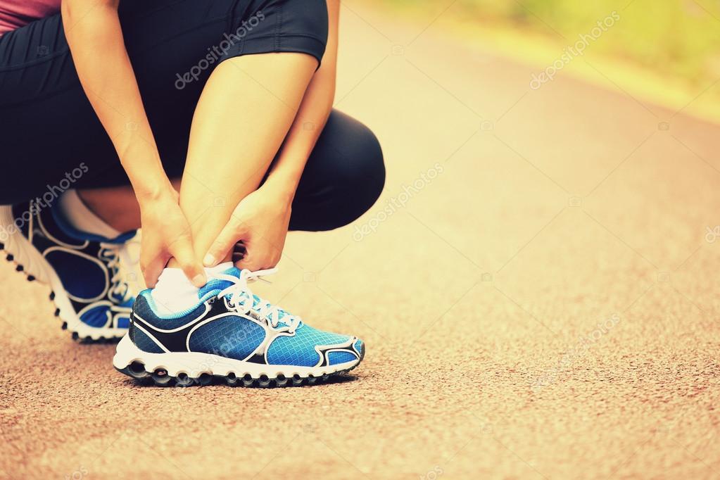 Woman runner hold her twisted ankle — Stock Photo © lzf #53228807