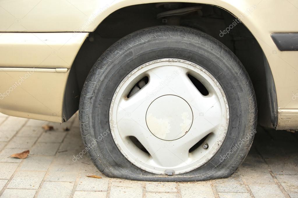 Flat tyre on car wheel Stock Photo by ©lzf 54332441