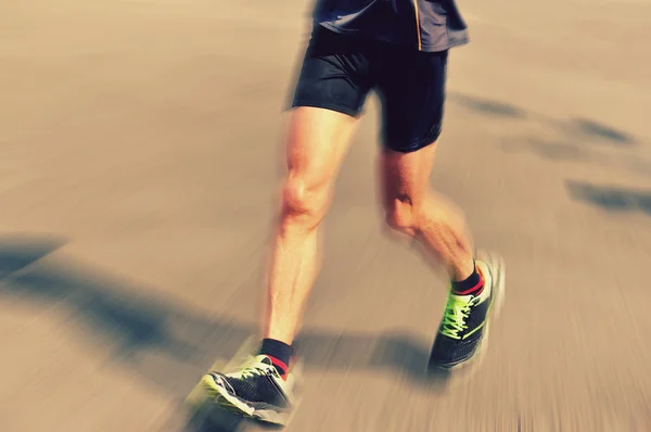 Marathon runner legs running on city road Stock Photo by ©lzf 59057129