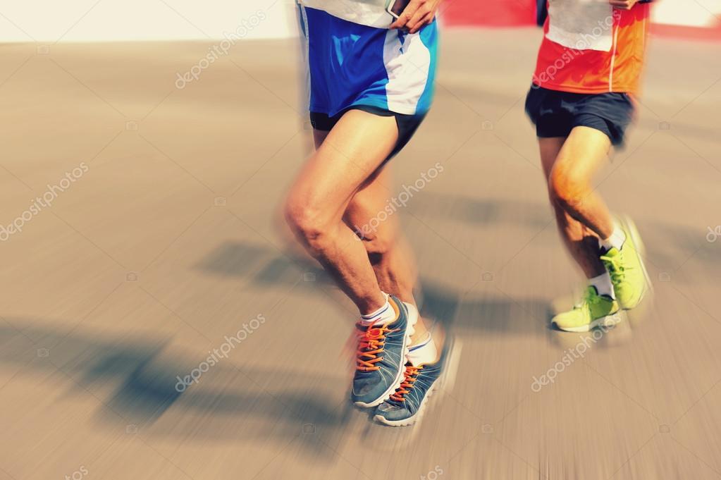 Marathon runner legs running on city road Stock Photo by ©lzf 59057129