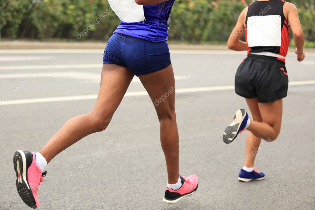 Marathon runners on road Stock Photo by ©lzf 84691630