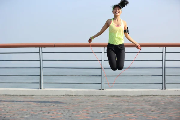 Woman jumping with rope Stock Photo by ©lzf 92324020