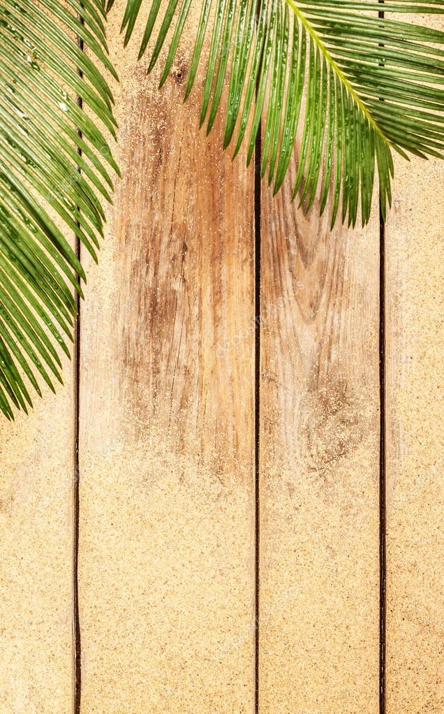 Palm tree leaves and sand on wood background Stock Photo by ©Pinkyone ...
