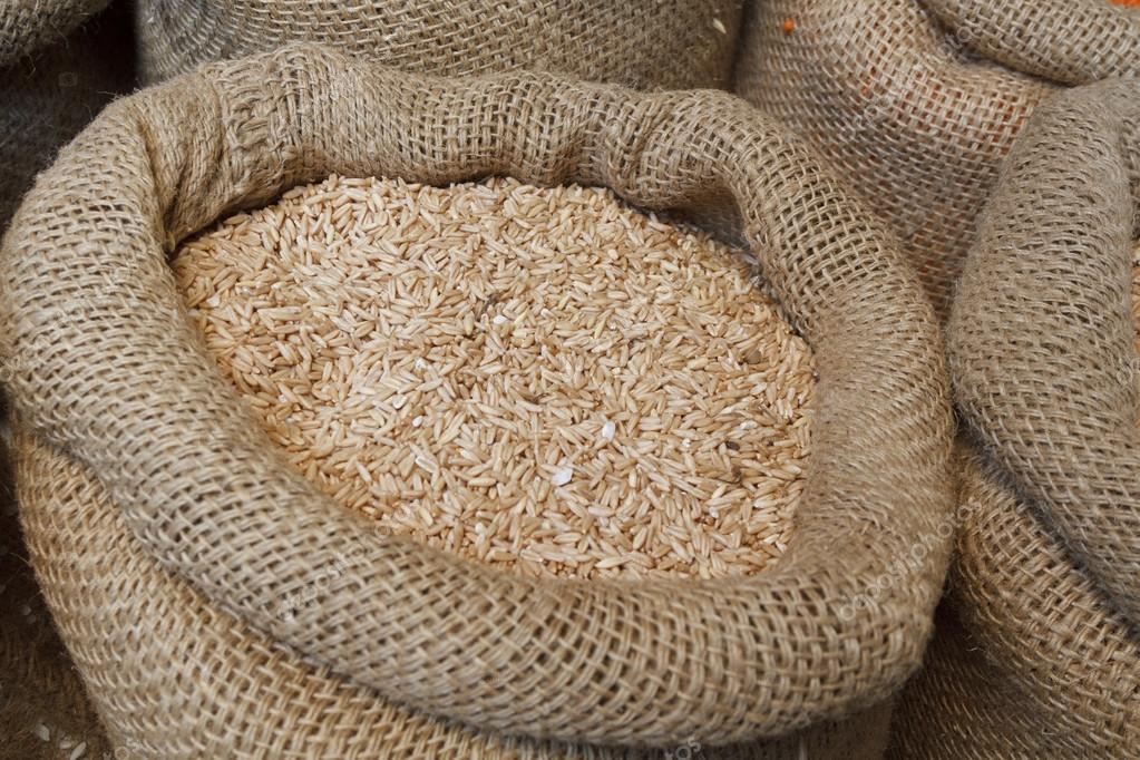 Rice in jute sack — Stock Photo © Veljanovski #53678489