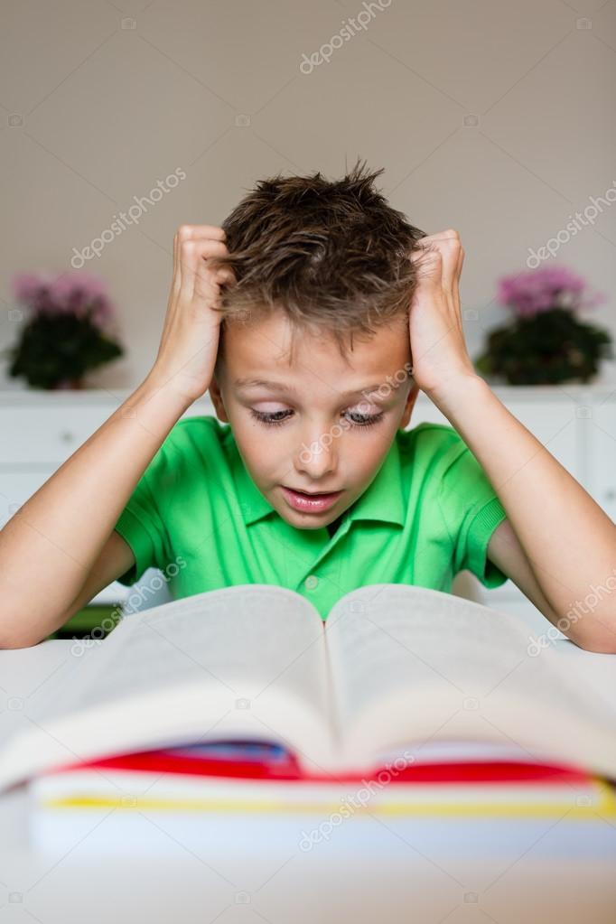 Frustrated young boy with book — Stock Photo © Bigandt #108002756