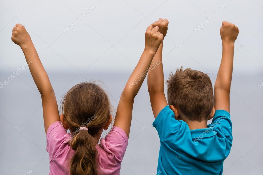 Kids with raised arms Stock Photo by ©Bigandt 51865729